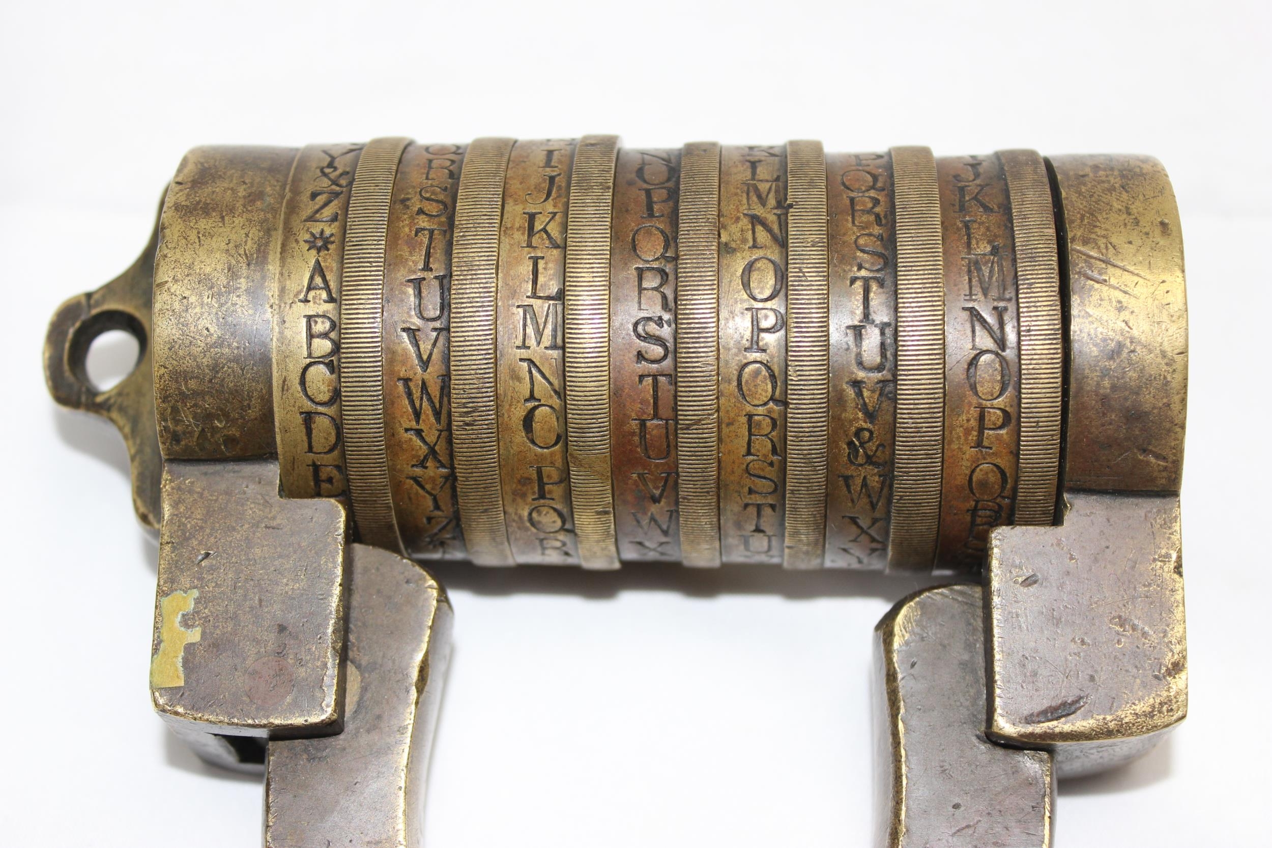 A rare and unusual cryptex style letter coded brass padlock with 7 ...