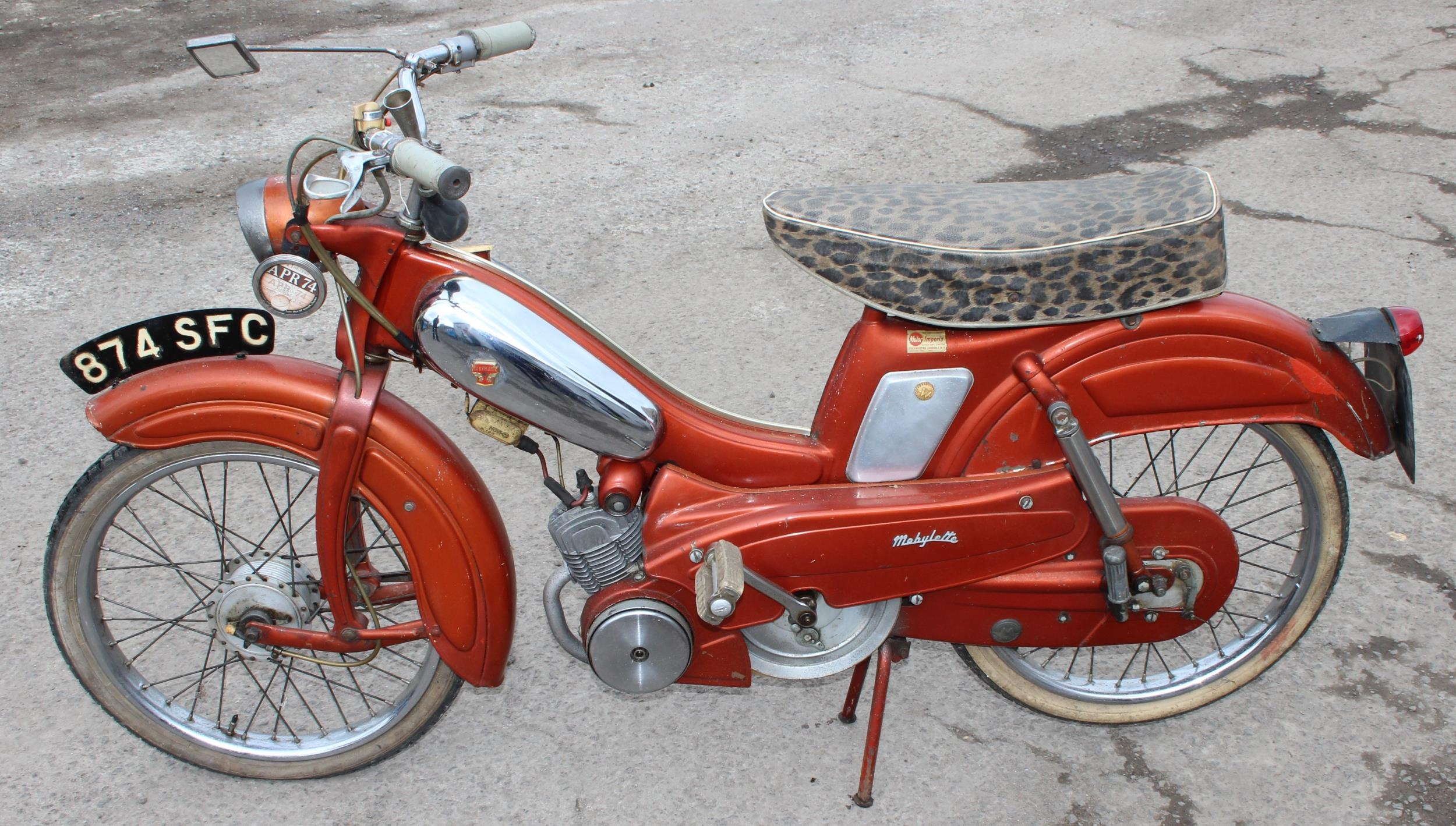 A vintage Mobylette Mobymatic moped with red painted body and leopard ...