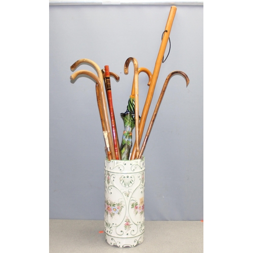 Decorative ceramic stick stand (43cm) with a qty of walking stick and ...