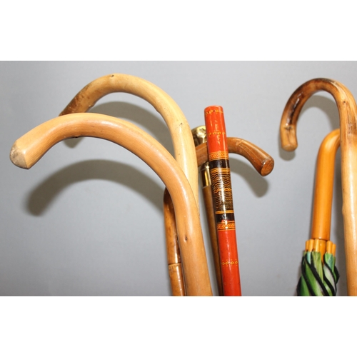 Decorative ceramic stick stand (43cm) with a qty of walking stick and ...
