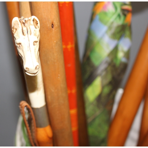 Decorative ceramic stick stand (43cm) with a qty of walking stick and ...