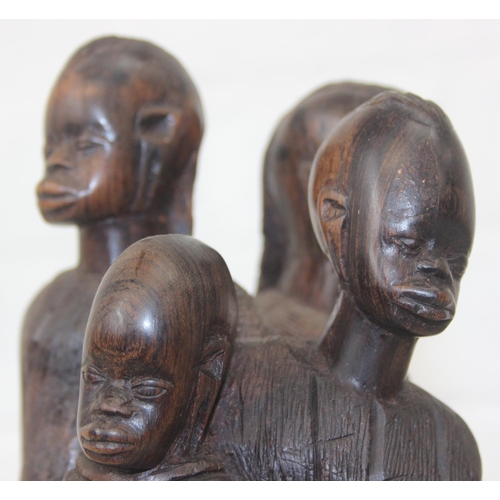 Three various carved African wooden statues of people, some in ...