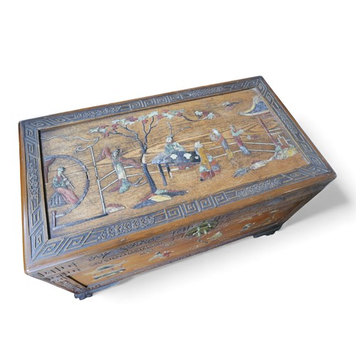 A mid 20th century Chinese camphor wood chest, with relief carved top ...
