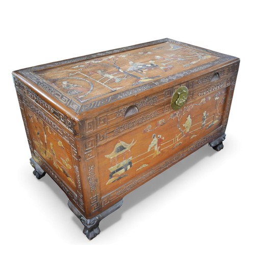 A mid 20th century Chinese camphor wood chest, with relief carved top ...