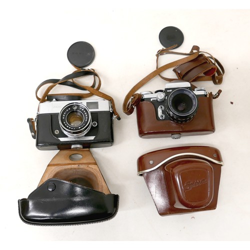 A collection of vintage cameras and camera equipment including a ...