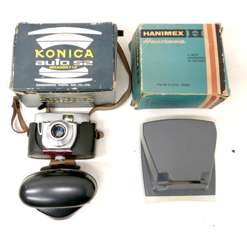 A collection of vintage cameras and camera equipment including a ...