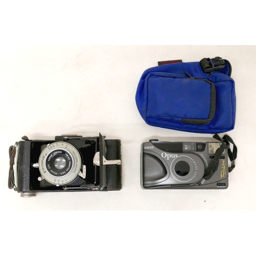A collection of vintage cameras and camera equipment including a ...