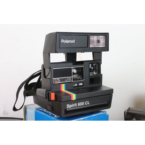 A collection of vintage cameras to include polaroid examples.