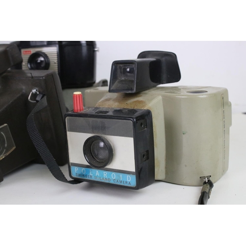 A collection of vintage cameras to include polaroid examples.