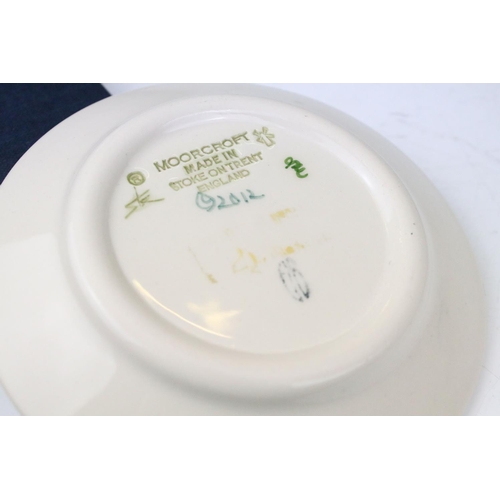 Four boxed Moorcroft pottery pin dishes to include True Blue, Snowberry ...