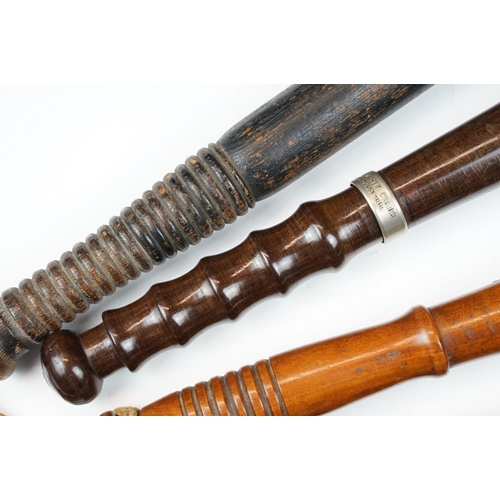 Four turned wooden truncheons to include an early 20th century example ...