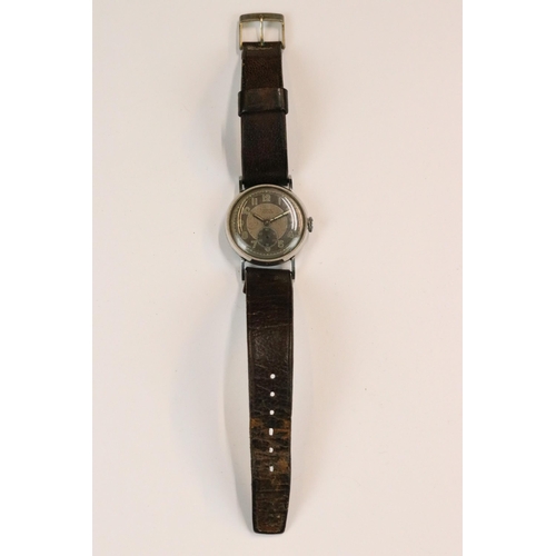 A 1940's French wristwatch with black dial, lumed hands and hour markers.