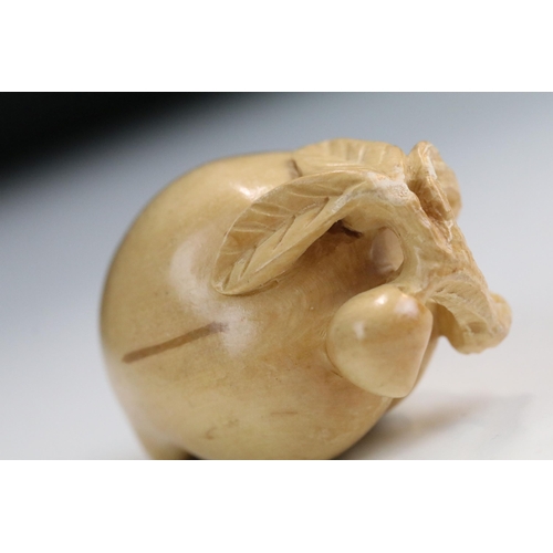 Two carved wooden netsuke figures of fruit