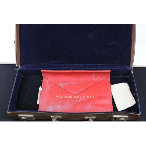 A collection of masonic jewels within a leather masonic case.