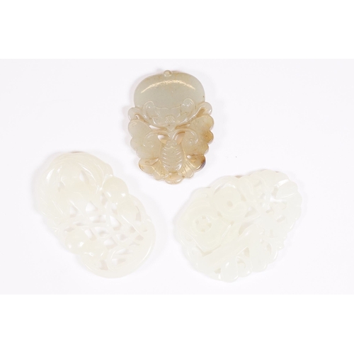 Collection of three Chinese carved jade pendants including two light ...