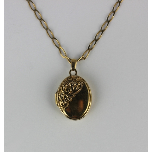 A 9ct gold oval pendant locket with foliate scroll decoration on a 9ct ...