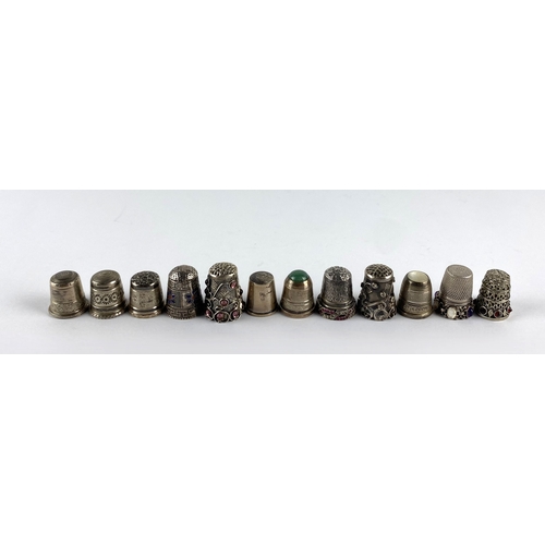 A group of eight silver thimbles and three white metal examples, to ...