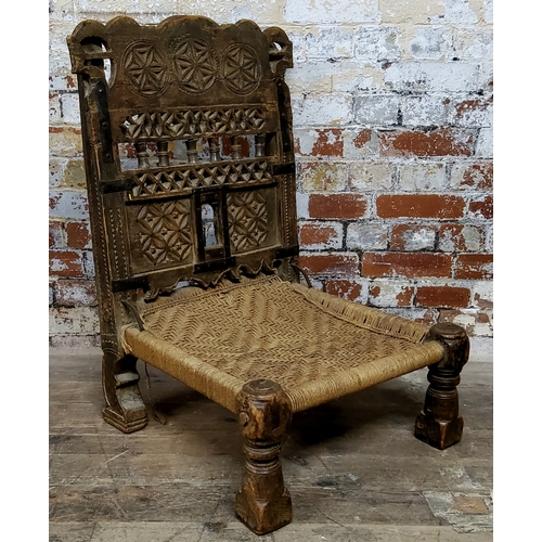 A 19th century Indian Pida Rajasthani low chair, the chip carved ...