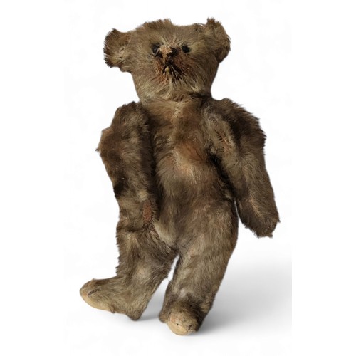 An early 20th century mohair bear, pointed snout, button eyes, small ...