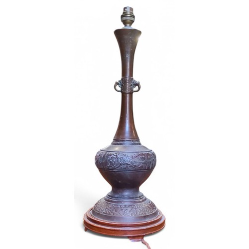 An early 20th century archaistic patinated bronze table lamp, plinth ...