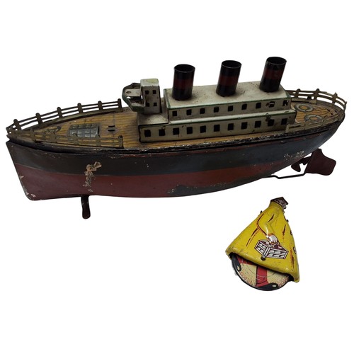 A German Arnold? tinplate clockwork three funnel liner, loose top ...