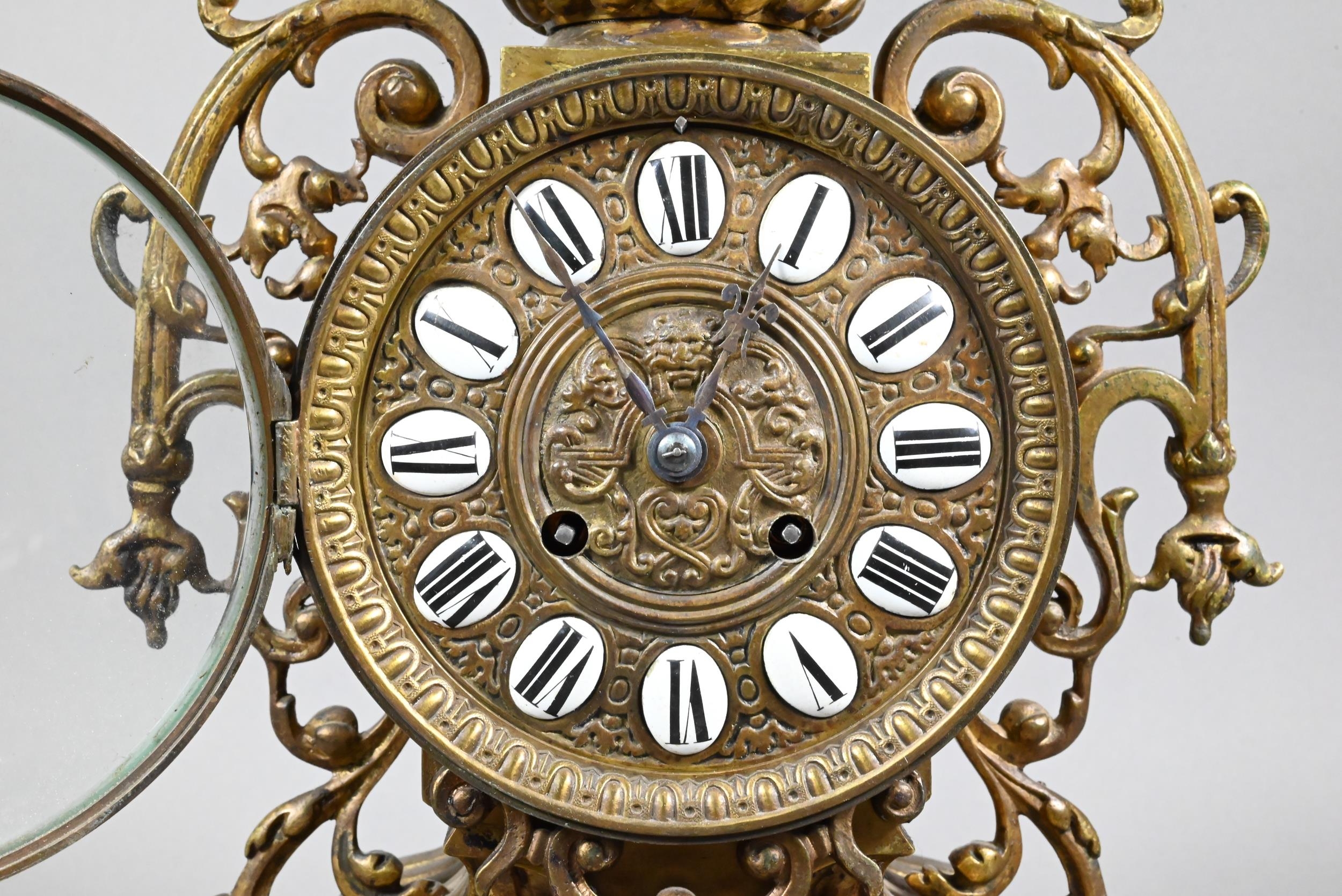 A Rococco style ornate cast brass 8-day mantel clock, the drum movement ...