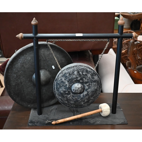 WITHDRAWN Two brass dinner-gongs - one on frame, with clapper
