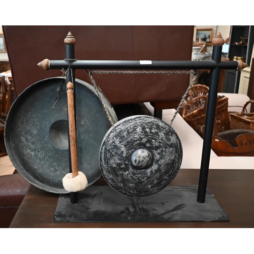WITHDRAWN Two brass dinner-gongs - one on frame, with clapper