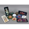 Four unboxed Moorcroft rectangular 20 x 9 cm dishes, to/w two ashtrays ...