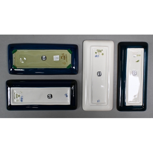 Four unboxed Moorcroft rectangular 20 x 9 cm dishes, to/w two ashtrays ...