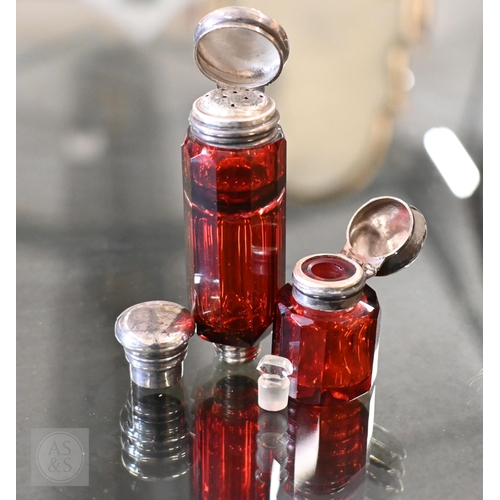 A Victorian ruby glass double-ended scent flask/vinaigrette with unmarked white metal ends, to/w a s