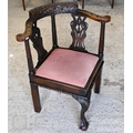 A pair of Georgian style floral carved oak corner chairs with pink ...