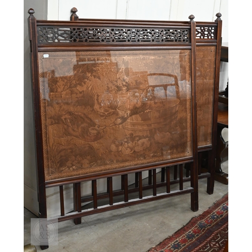A two panel mahogany framed fret cut screen with glazed panels over ...