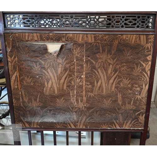 A two panel mahogany framed fret cut screen with glazed panels over ...