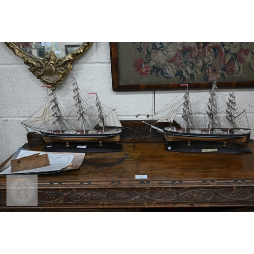 A pair of model three-masted tea clippers on stands, one with Cutty ...