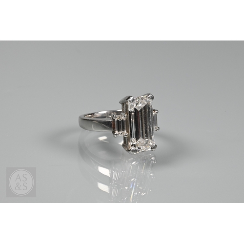 An exceptional diamond ring, the cut-cornered step-cut diamond with ...