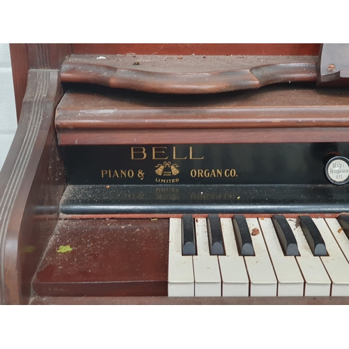 A walnut cased Bell Piano & Organ