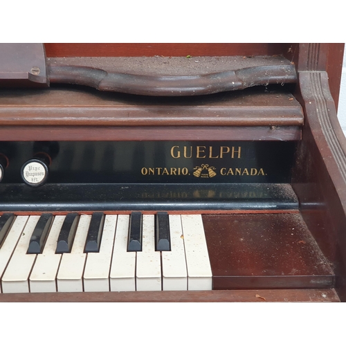 A walnut cased Bell Piano & Organ