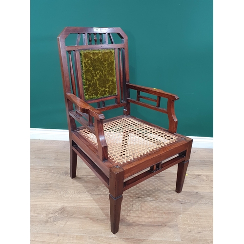 A walnut framed open Elbow Chair with cane seat