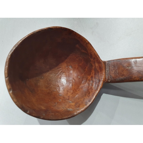 A collection of treen Spoons including two Toddy Ladles, two Ladles, a ...