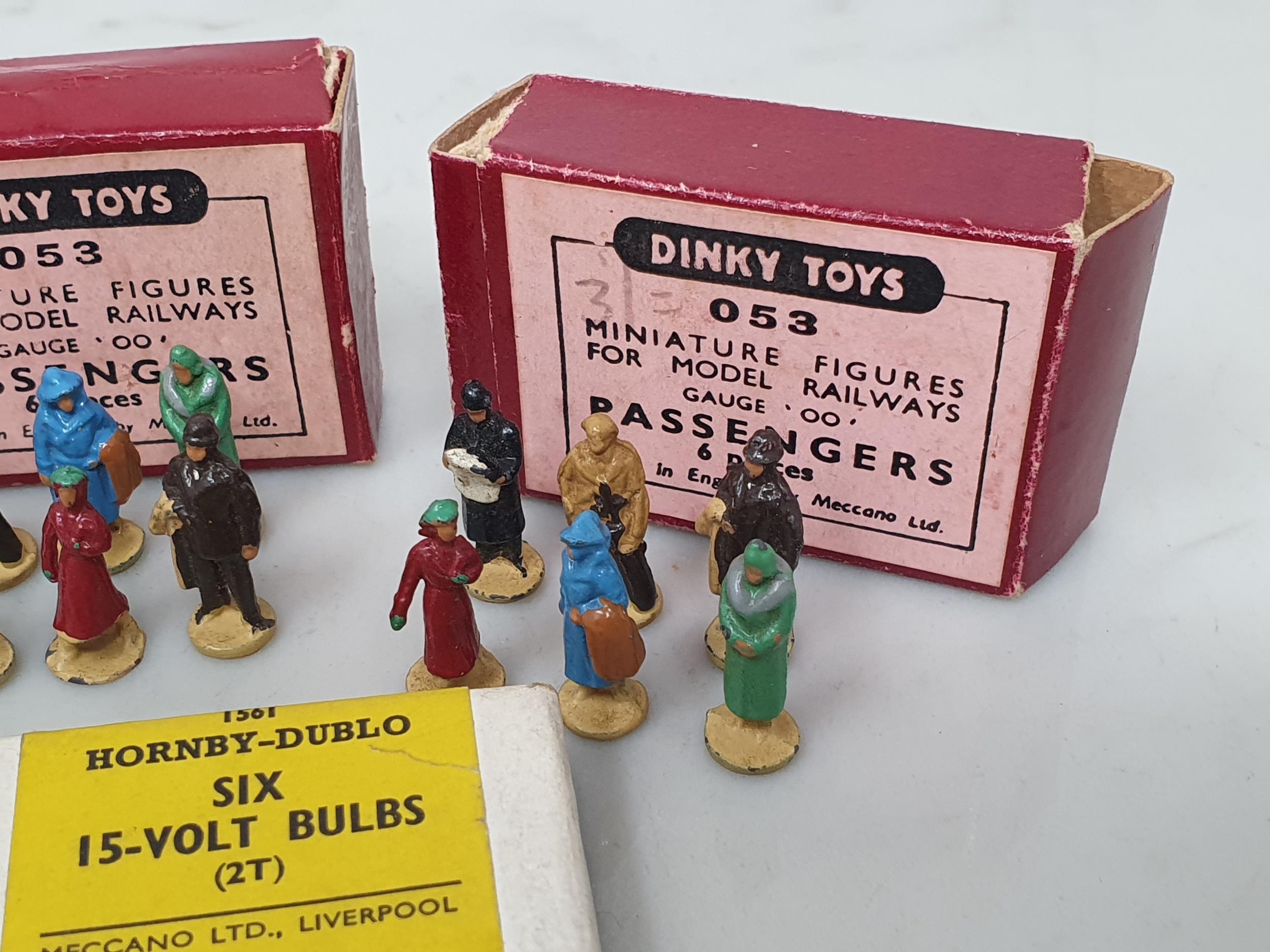 Dinky Toys 051 Station Staff, two Dinky Toys 053 Passengers and a boxed ...