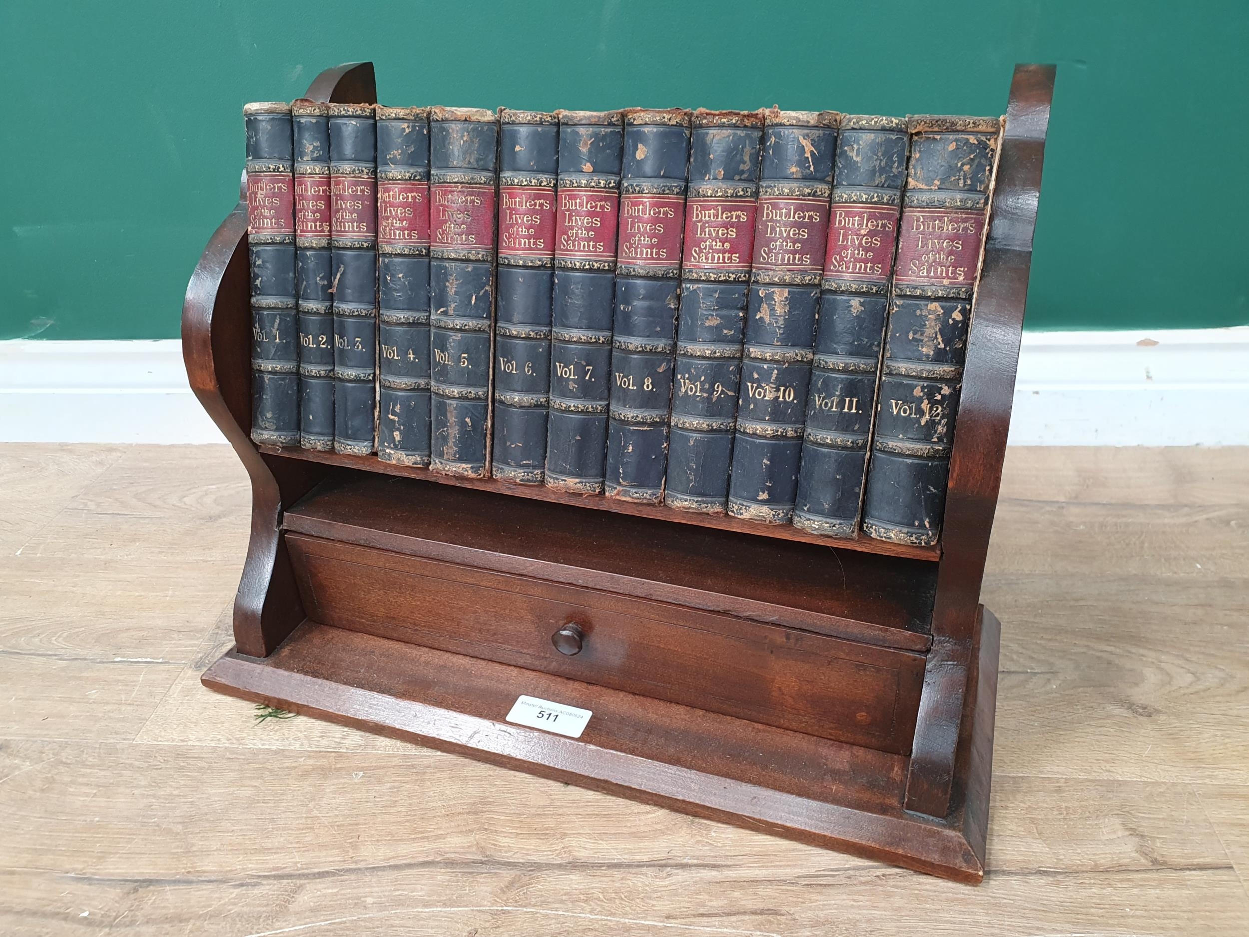 A hardwood table top Book Shelf with carved acorn designs with twelve ...