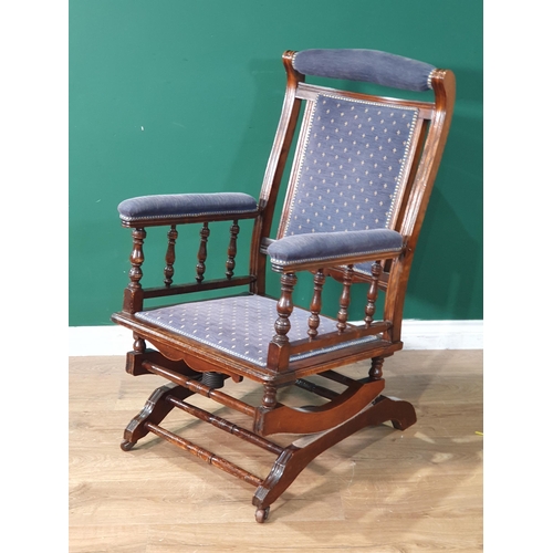A stained mahogany blue upholstered American style Rocking Chair, (R2).