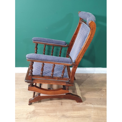 A stained mahogany blue upholstered American style Rocking Chair, (R2).