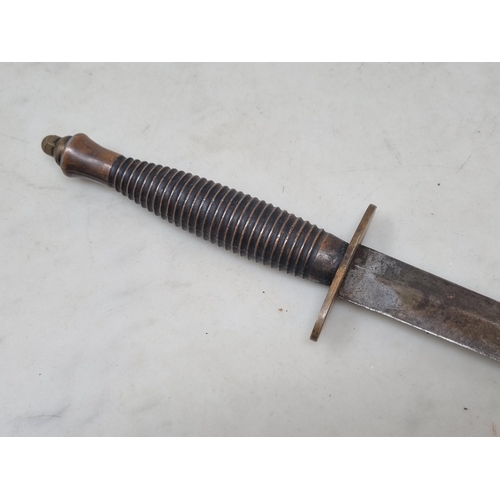 A Fairbairn Sykes 3rd Pattern Fighting Knife in associated leather sheath