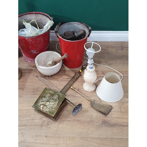 Two red painted Fire Buckets, a brass and ceramic Kettle Stand, a ...