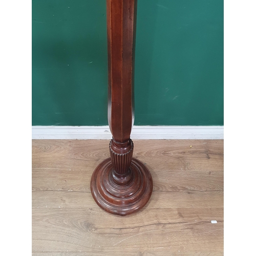 A 19th Century mahogany Torchere, the octagonal baluster column with ...