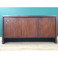 A mid Century Sideboard by Dillingham, fitted three cupboard doors ...