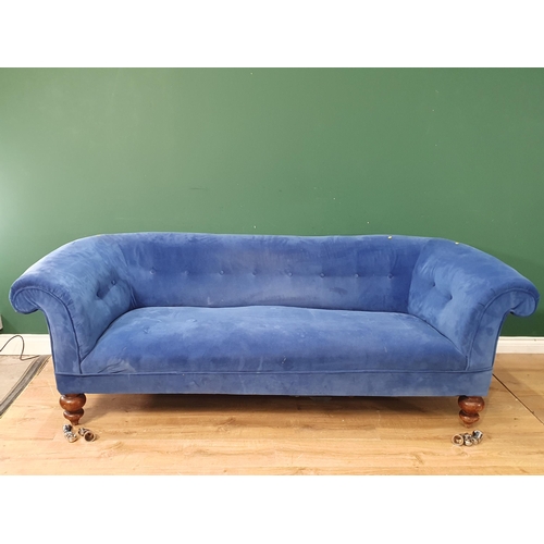 A blue upholstered Chesterfield Sofa with button back design, raised on ...
