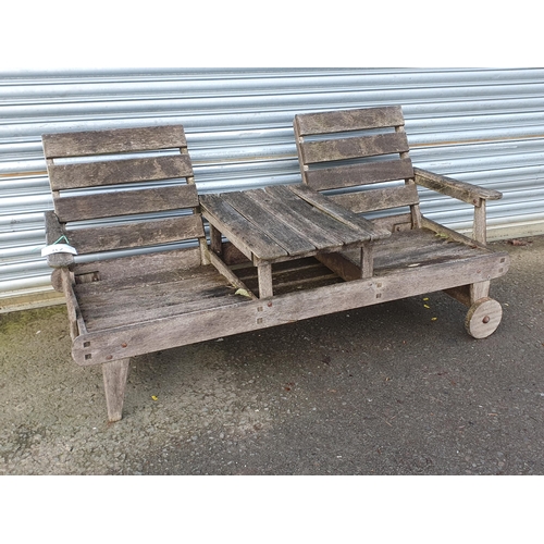 A Two seater Garden Bench with fitted table.